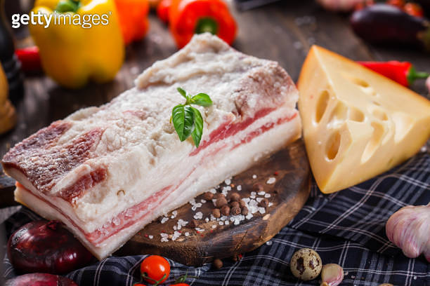 fresh lard pork lard with salt, on a kitchen cutting board, hard cheese ...