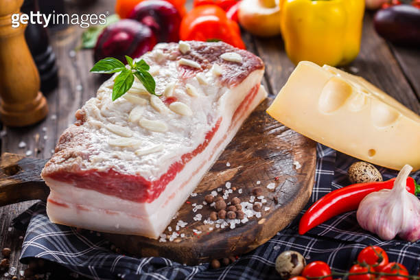 fresh lard pork lard with salt, on a kitchen cutting board, hard cheese ...