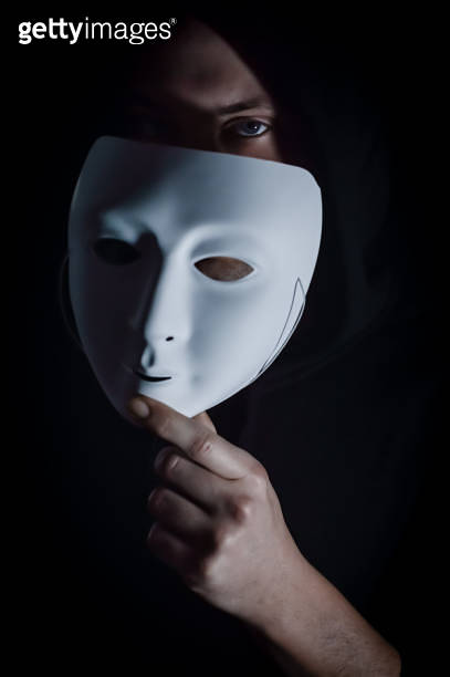 Take off the mask - Portrait of a young hooded man who takes off his ...