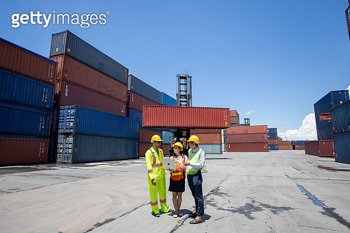 Manager standing and meeting with his staff in container depo company ...