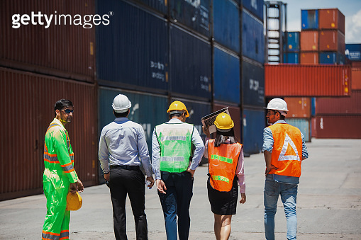 Manager standing and meeting with his staff in container depo company ...