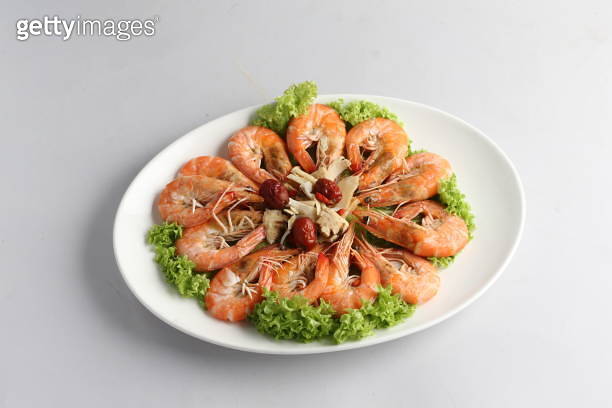 steamed fresh poached tiger prawn with vegetable lettuce on white plate ...