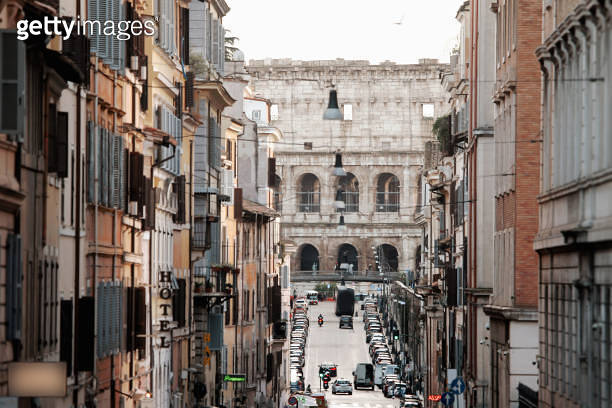 The Coliseum as seen from a narrow historic street in downtown Rome ...