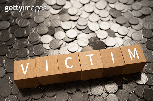 Wooden blocks with "VICTIM" text of concept and coins. (1426543158 ...