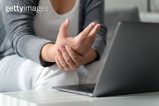 woman holding her hand pain from using computer long time. Office ...