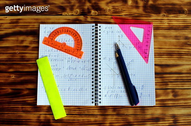 Educational notebook in mathematics with numbers and tasks with a pen ...
