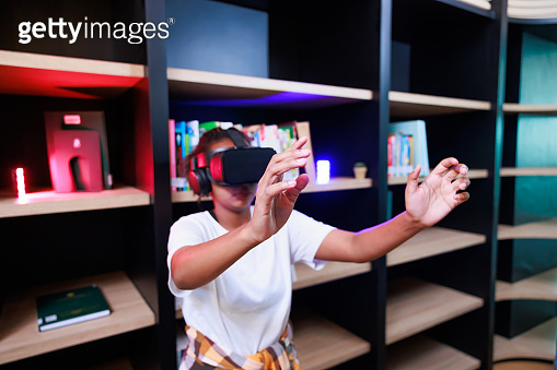VR headset library. Young teen girl student training and learning with ...