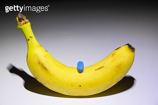 Upwards yellow banana with a blue erection pill, concept of the effect ...