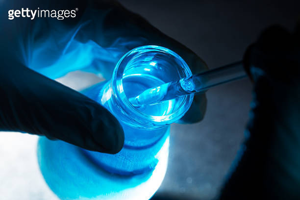 Blue science experiment glass tube,Researchers with chemistry test ...