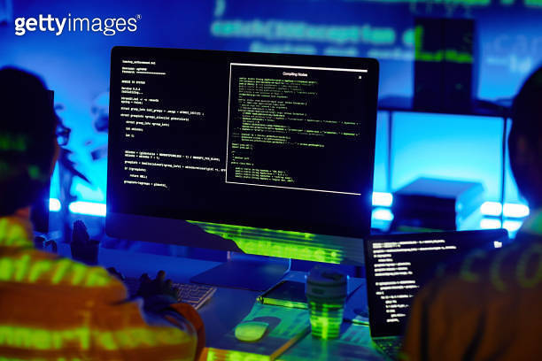 Computer screen with decoded data and two young contemporary ...