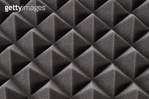 Close up of dark gray triangular acoustic and studio sound proof foam ...