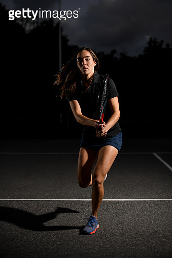 view of active female tennis player running with tennis racket on ...
