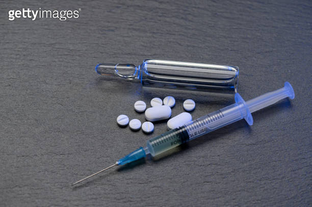 Medical vial and ampoules for injection and syringe and pills on the ...