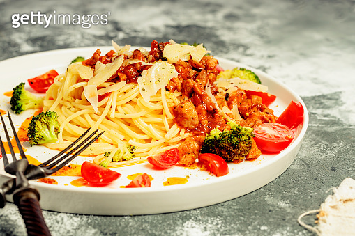 Close-up Appetizing pasta with meat in tomato sauce, vegetables and ...