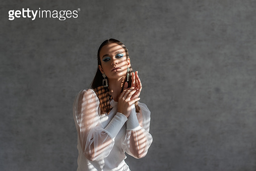 Close-up beauty portrait of girl, clean skin. Light shadow stripes ...