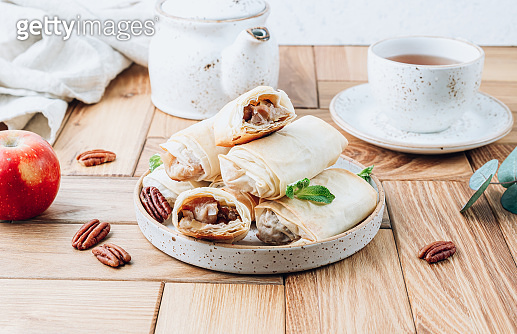 Mini apple strudel with pecans and mint on wooden table. Viennese ...