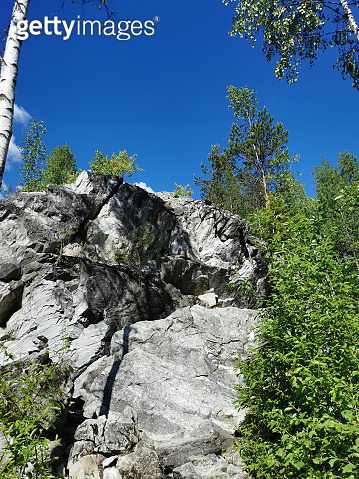 Catherine's marble cliff surrounded by trees in Ruskeala Mountain Park ...