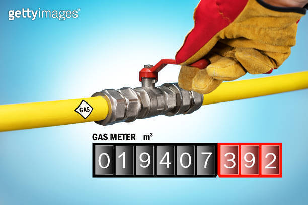 Natural Gas Meter and hand in glove while opening or closing a manual ...