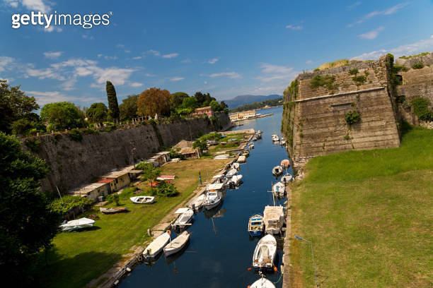 corfu city in spring view from fortress sea ships green trees in greece ...