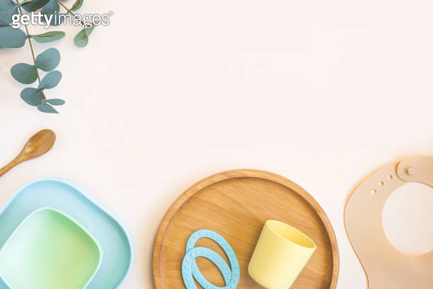 Baby accessories and tableware for food on beige background. First ...