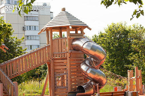 Modern children's playground for outdoor games, a slide pipe made of ...