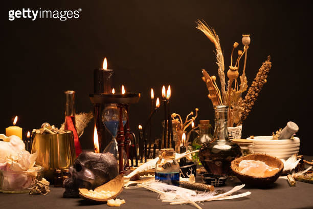 Witch ceremony with witch craft magic items. Selective focus at front ...