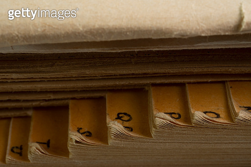 Old vintage withered English dictionary book with alphabet side view ...