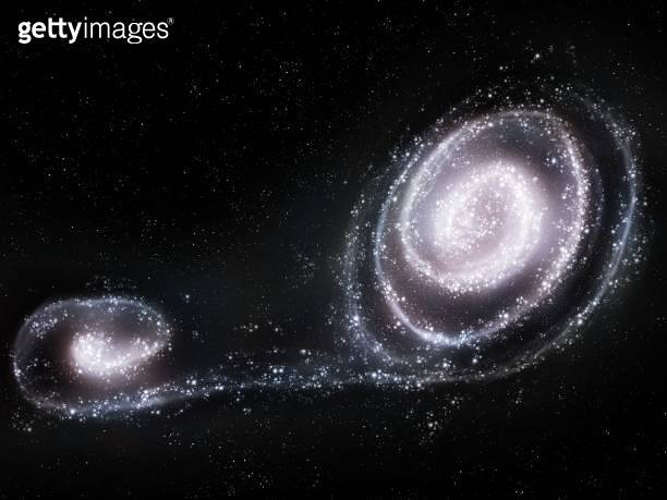 Galaxy mergers. Large spiral galaxy engulfs a companion dwarf galaxy ...
