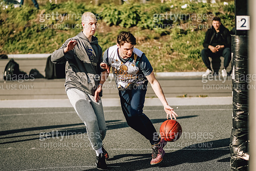 People playing streetball at the street. Sports photography with ...