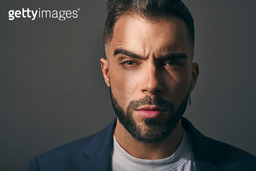 Male model shot in studio. Serious and confident expression. Angry or ...