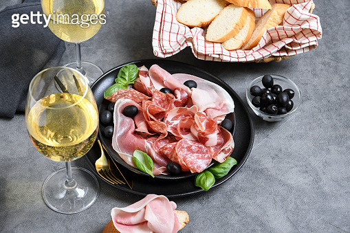 Food antipasto prosciutto ham, salami, olives and bread sticks ...