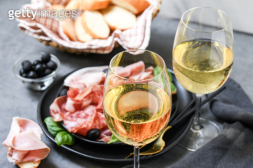 Food antipasto prosciutto ham, salami, olives and bread sticks ...