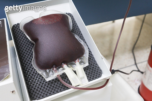 Blood bag from a blood donor placed on a donated blood shaking machine ...