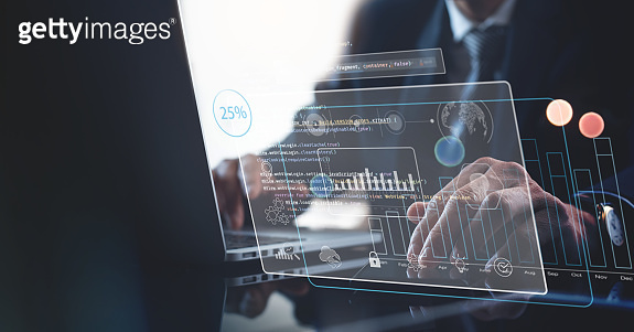Data analysis. Businessman using laptop and digital tablet analyzing business data, marketing ...