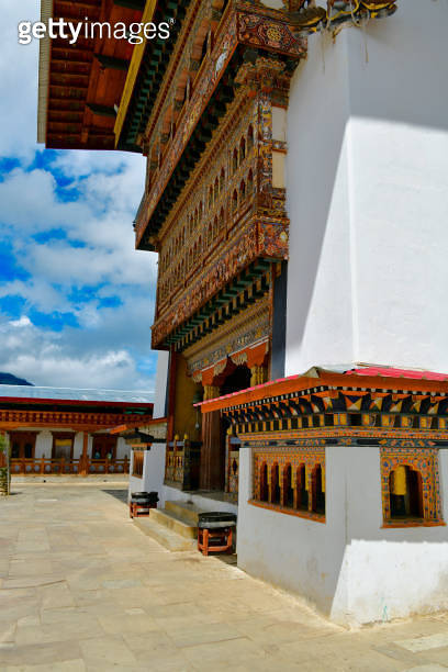Gangtey Monastery - façade with rabsel balcony and prayer wheels ...