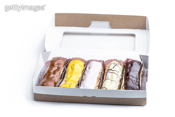 Set of decorated eclairs in paper box isolated on white (1372167713 ...