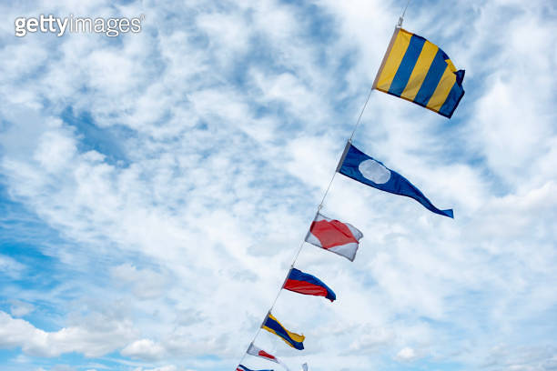 International code of signal flags flying with colorful maritime flags ...