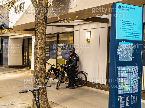 Seattle Police Bicycle Patrol Officers behind a tourist directory sign ...
