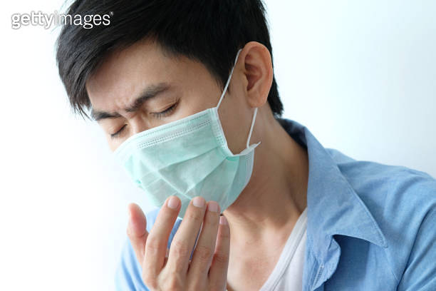 A man with flu and sneezing, he uses protective mask to prevent runny ...