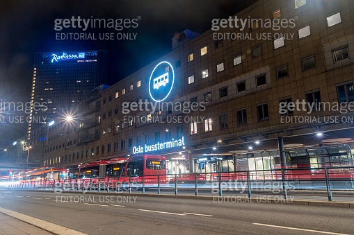 Oslo Bus Terminal at night. Bus terminal is a hub for regional and long ...