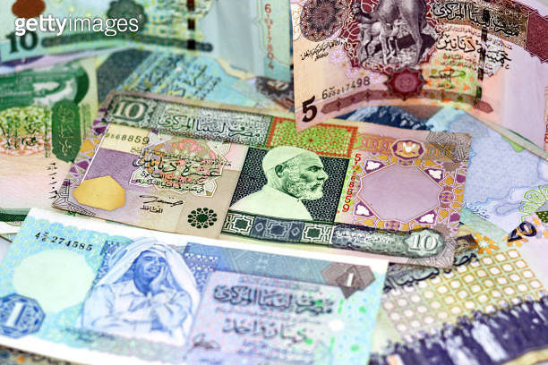 Background of Libyan money dinars banknotes with portraits of Omar Al ...