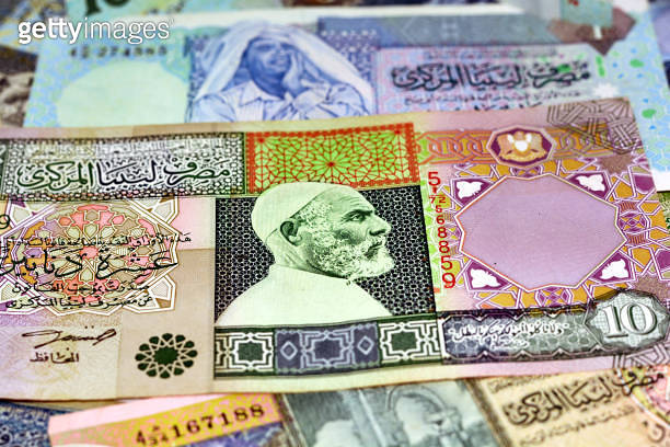 Background of Libyan money dinars banknotes with portraits of Omar Al ...