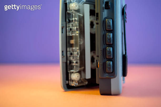 A vintage audio cassette and walkman with a 90's retro color palette ...