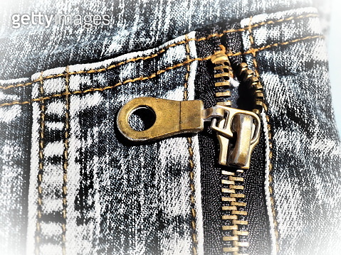 Close-up denim with seams and locks. Heavily shabby worn jeans. Metal ...