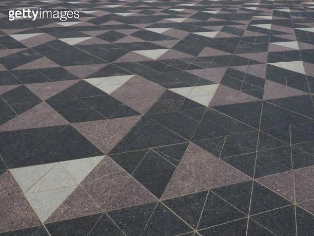 The square is paved with triangular tiles. Grey, white, black tiles on ...