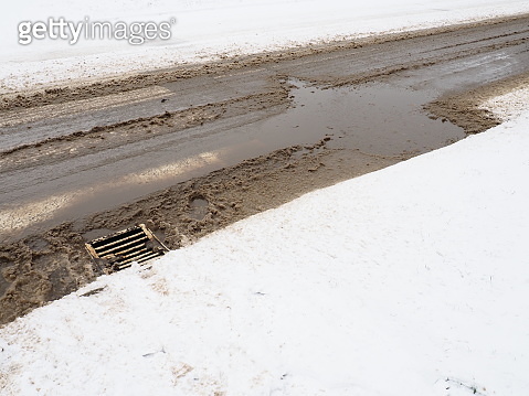 Snow, ice, slush and winter mud at a pedestrian crossing. The air ...