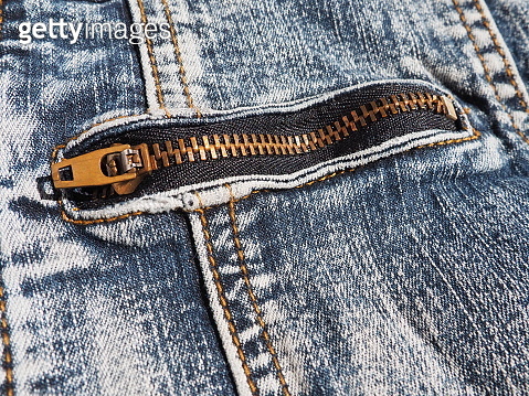 Close-up denim with seams and locks. Heavily shabby worn jeans. Metal ...