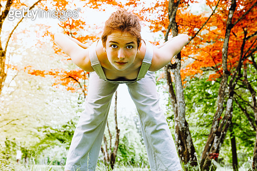With curious look, young attractive teenage girl looks at camera ...