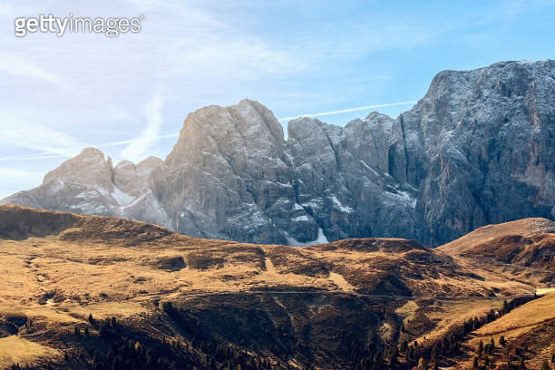Plateau of Seiser Alm covered with yellow autumn grass surrounded by ...