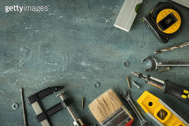 Handyman's tools. Flat lay of clamps, wrench, screwdriver, drill, angle ...